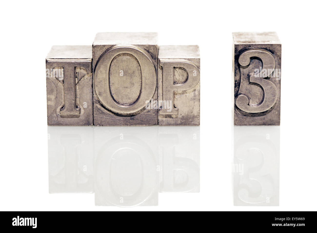 top three phrase made from metallic letterpress type on reflective ...