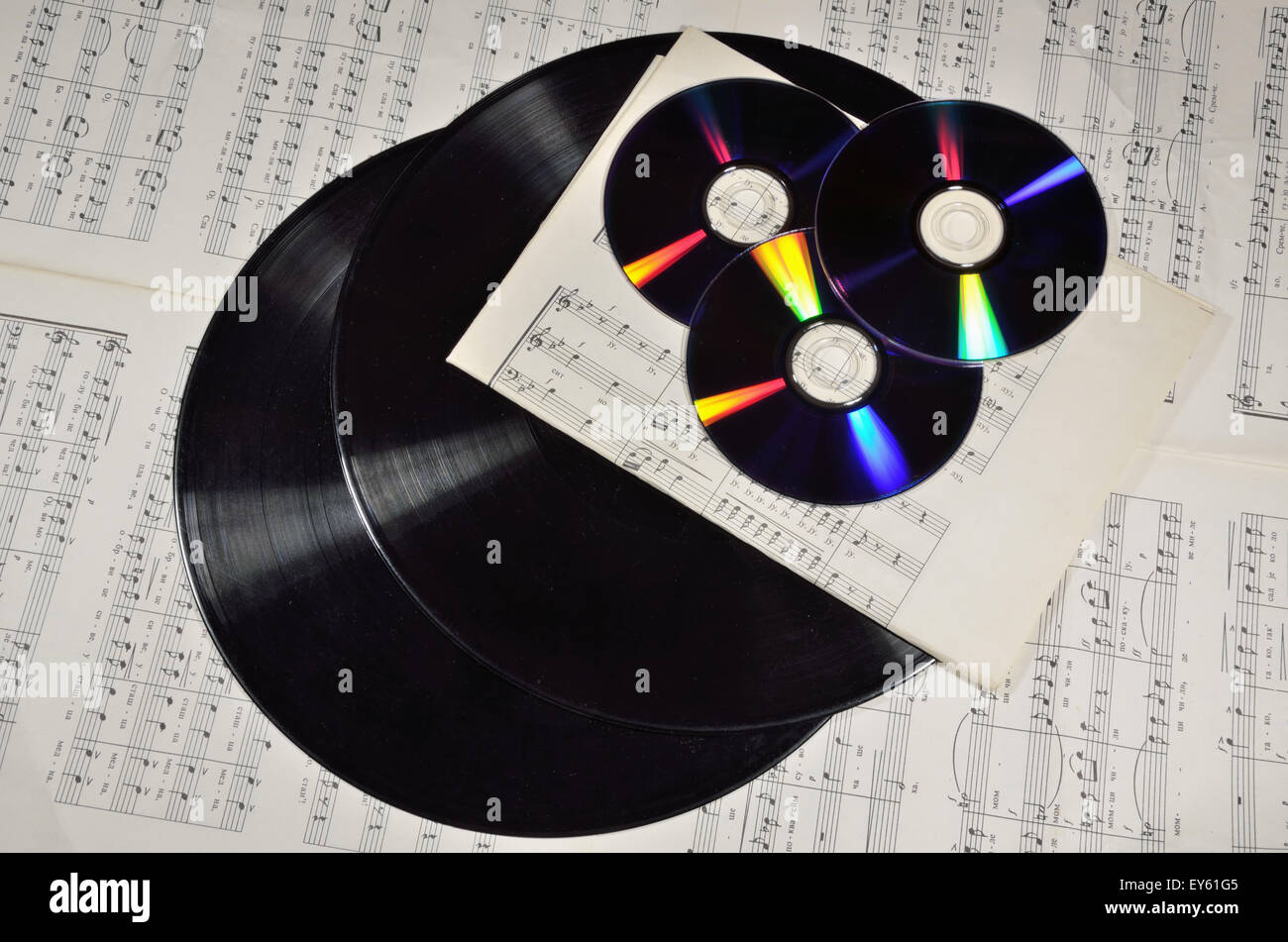 New and old generation of media. Same purpose. Dusty LP records and ...