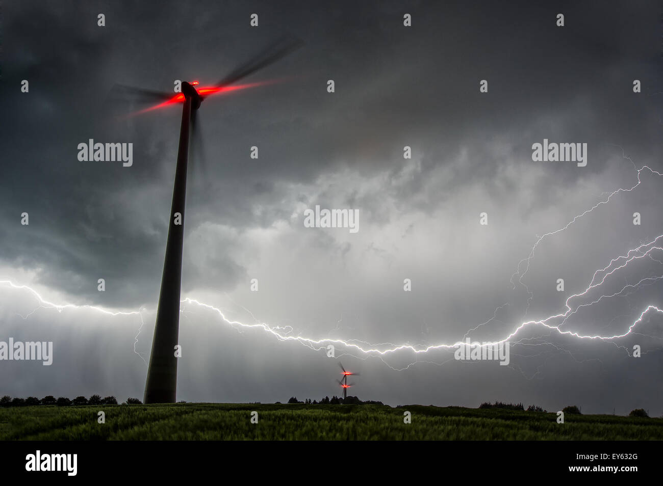 Lightning in clouds and windmill in the evening - France Stock Photo ...