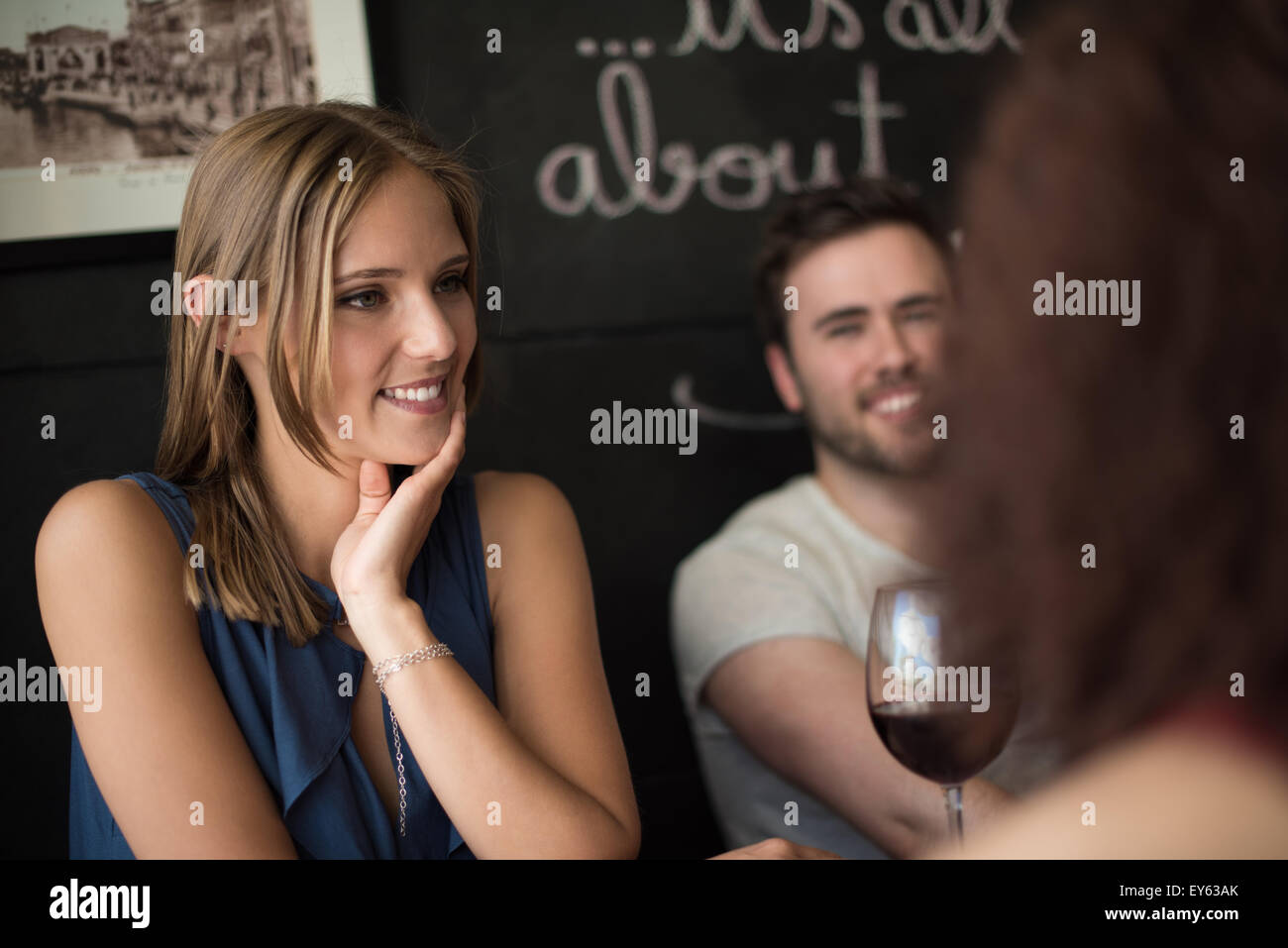 Multi ethnic friends talking and drinking in bar Stock Photo - Alamy