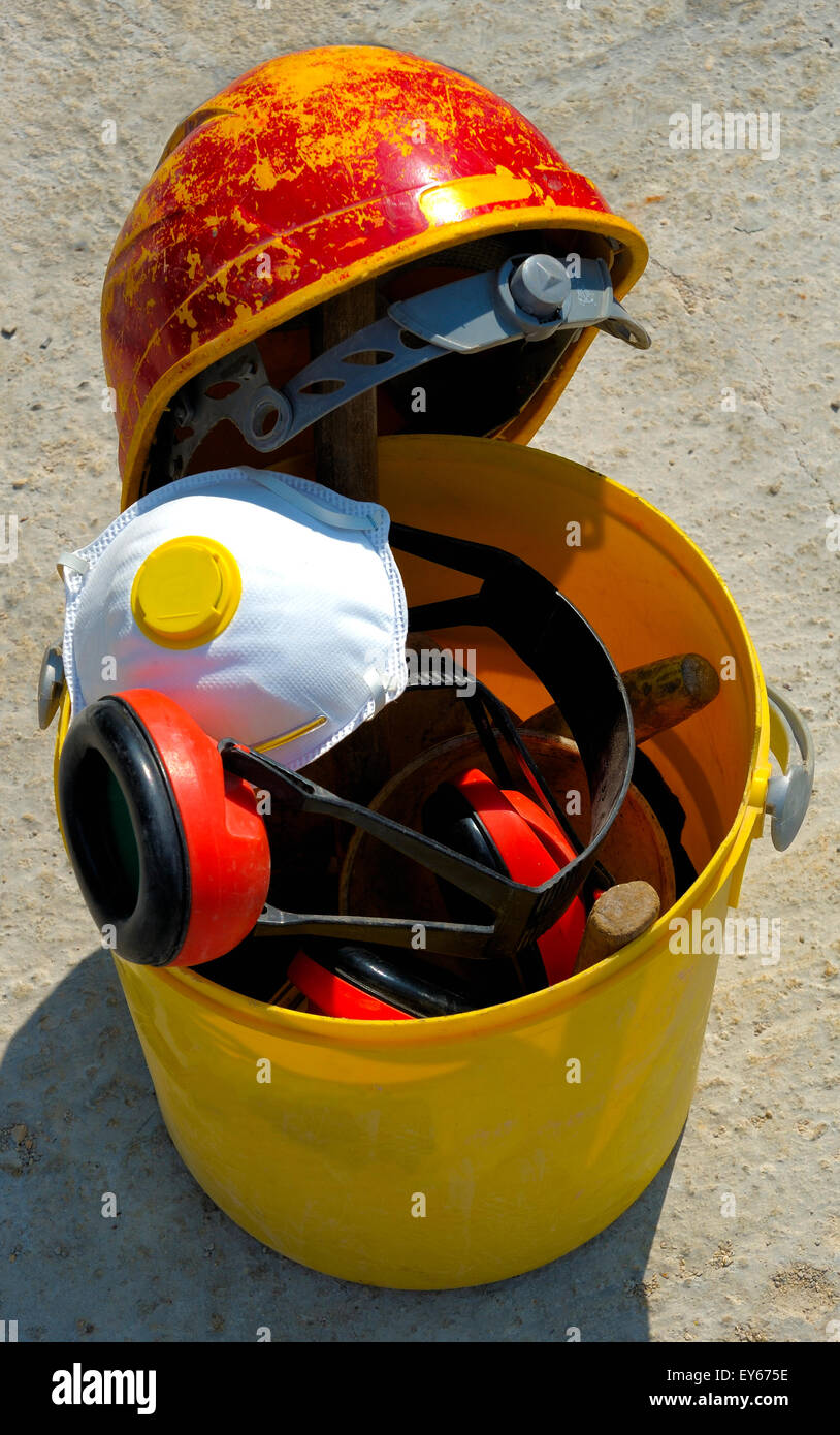 bucket with tools and construction safety equipment. Helmet, cap, mask ...