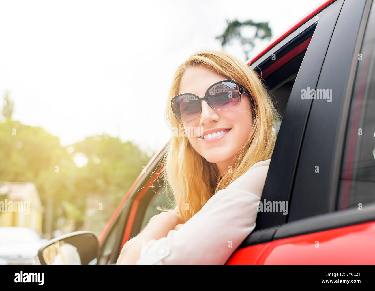 Woman in red car Stock Photo - Alamy