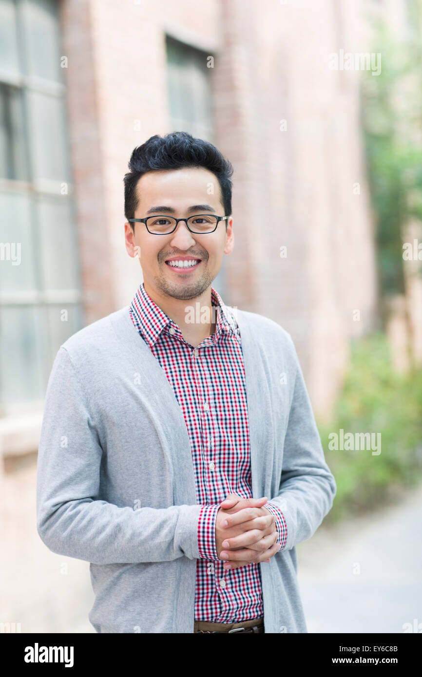 Mid adult man standing front brick wall hi-res stock photography and ...