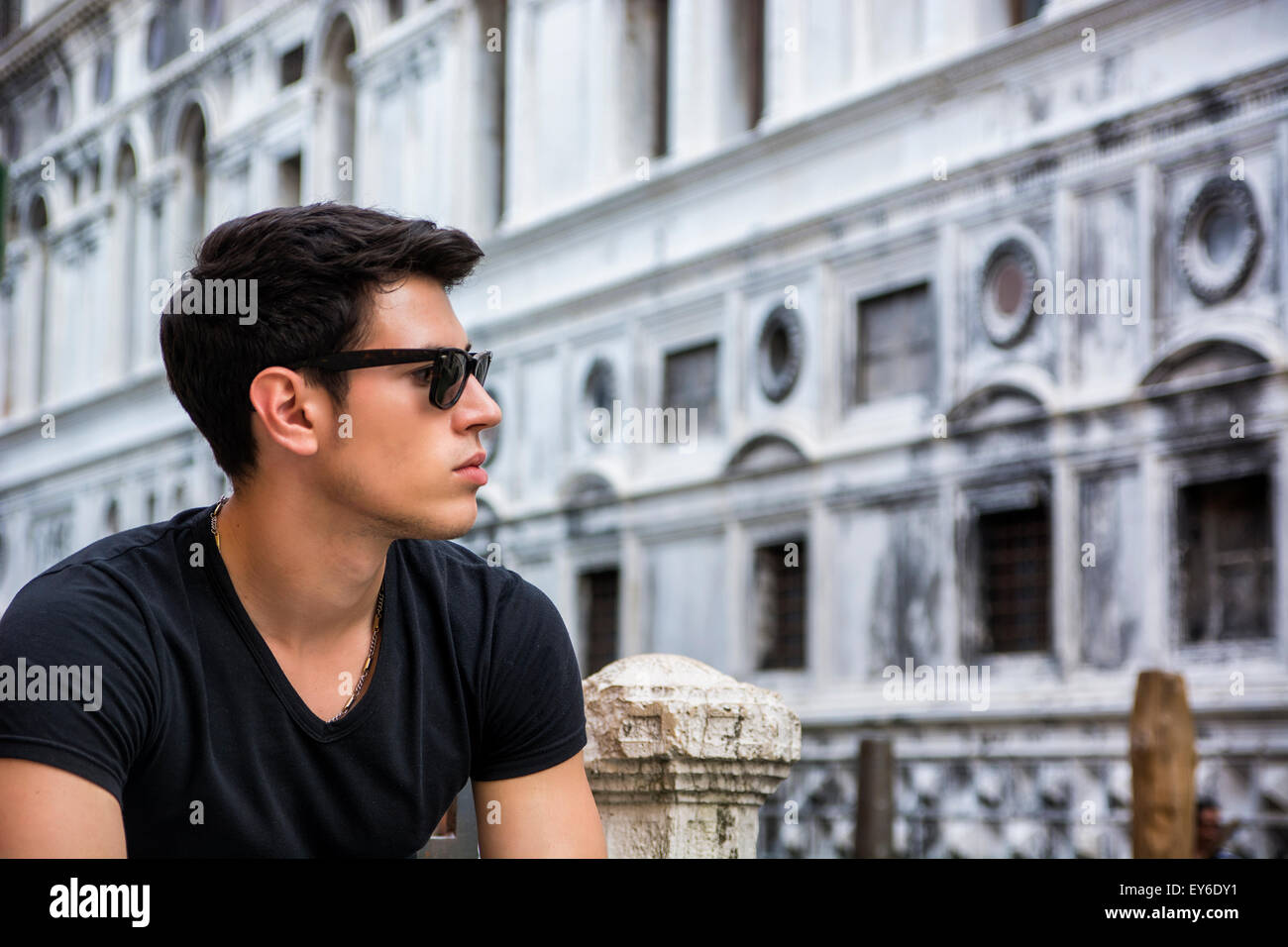 Portrait of Attractive Dark Haired Young Man Leaning Against Railing on ...
