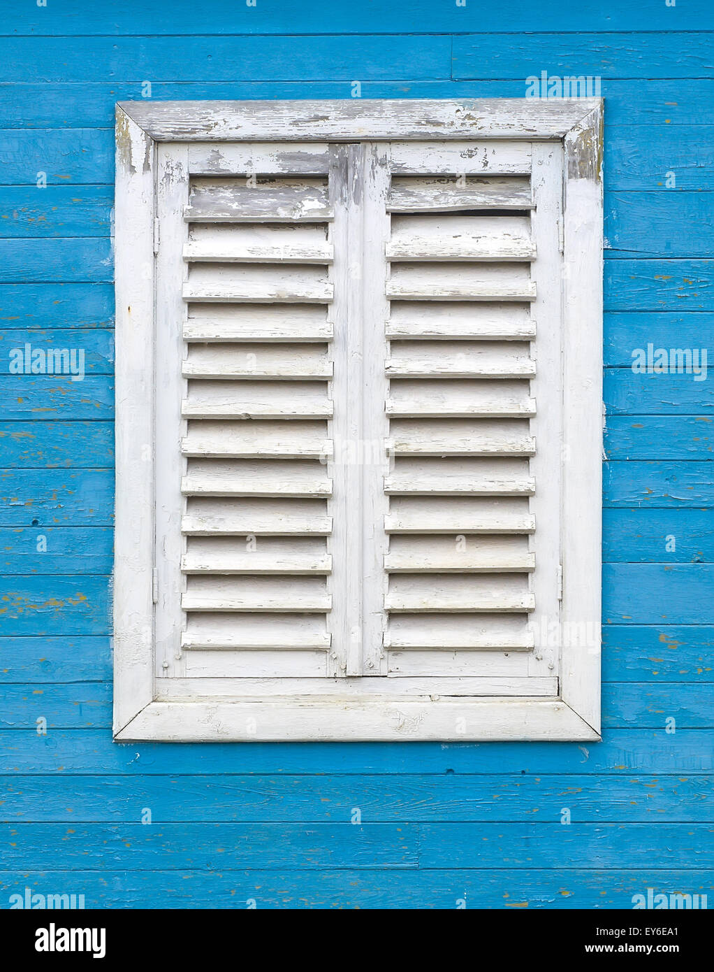 Old white window with wooden shutters on the blue wall of boards Stock ...