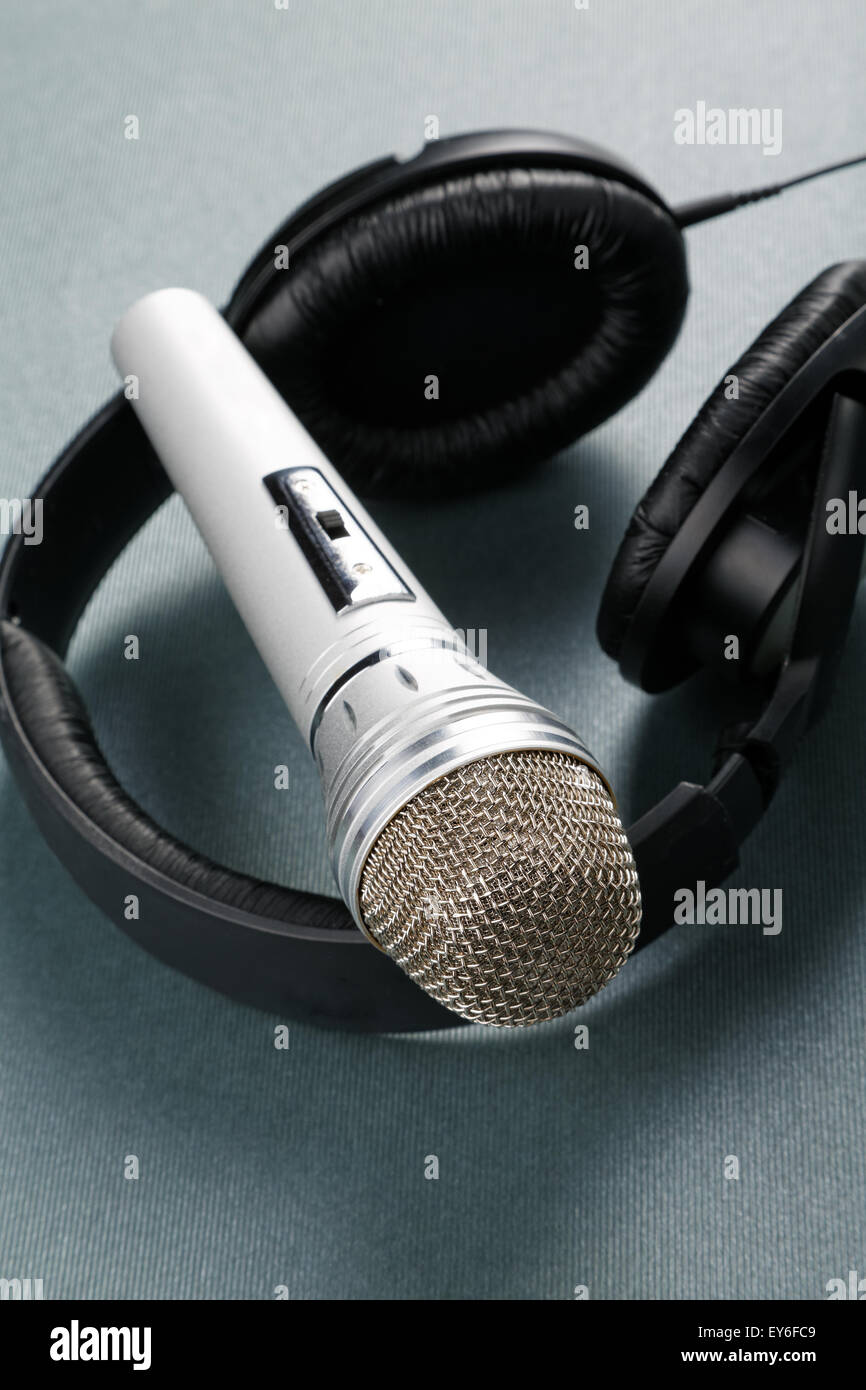 Microphone and ear-phones on a table Stock Photo - Alamy