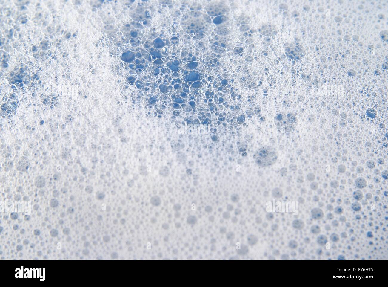 Suds and Soapy bubbles on blue water Stock Photo - Alamy