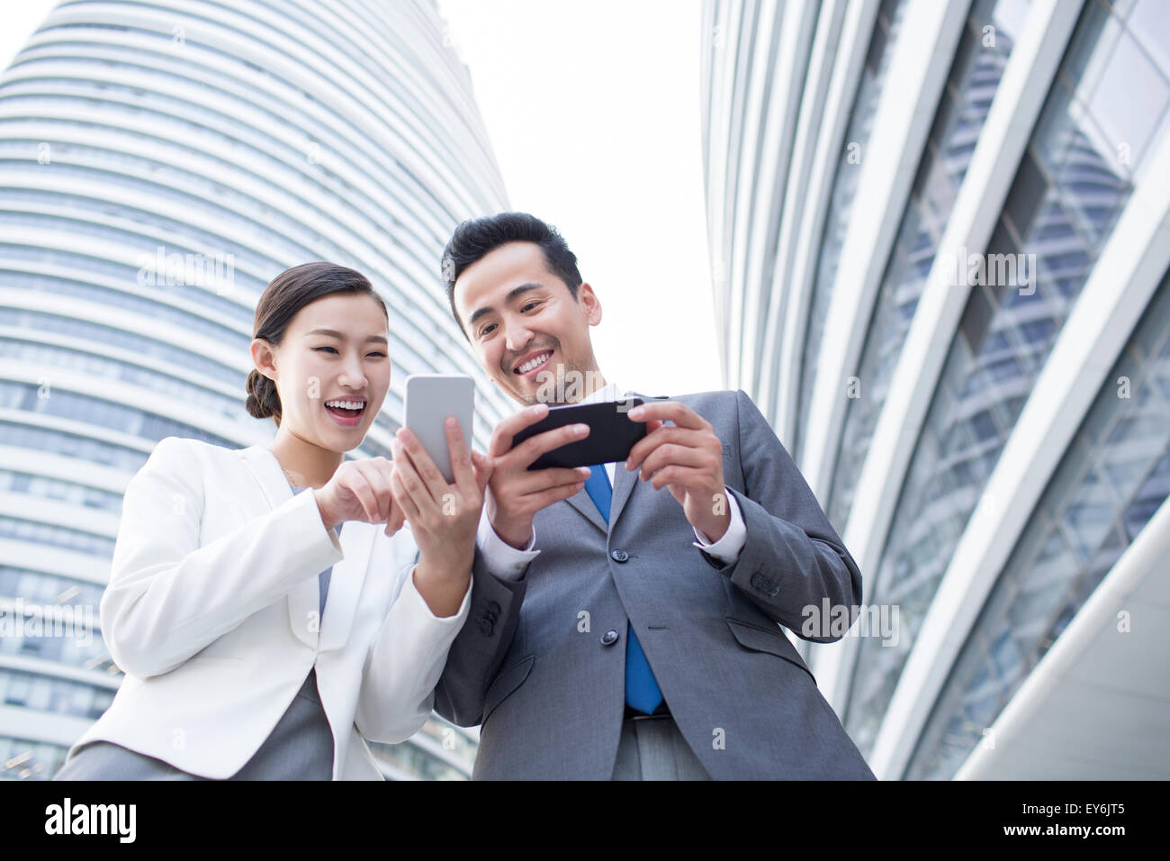 Business person using smart phones Stock Photo - Alamy