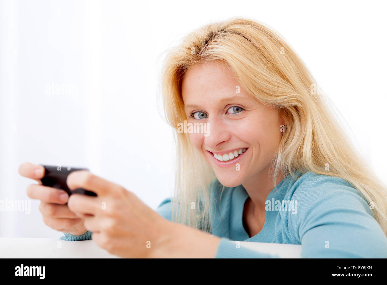View of Young relaxed woman sending text Stock Photo - Alamy
