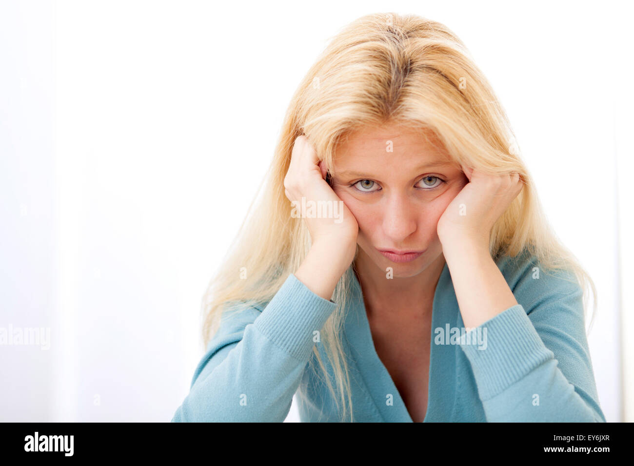 View of a Portrait of a blonde woman pulling a face Stock Photo - Alamy