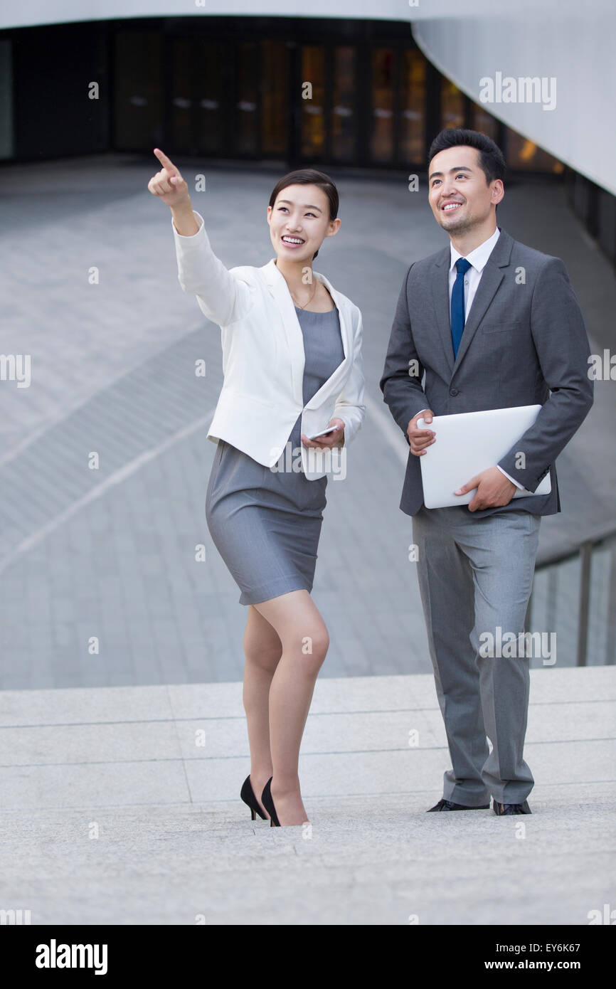 Business person pointing and looking at view Stock Photo - Alamy