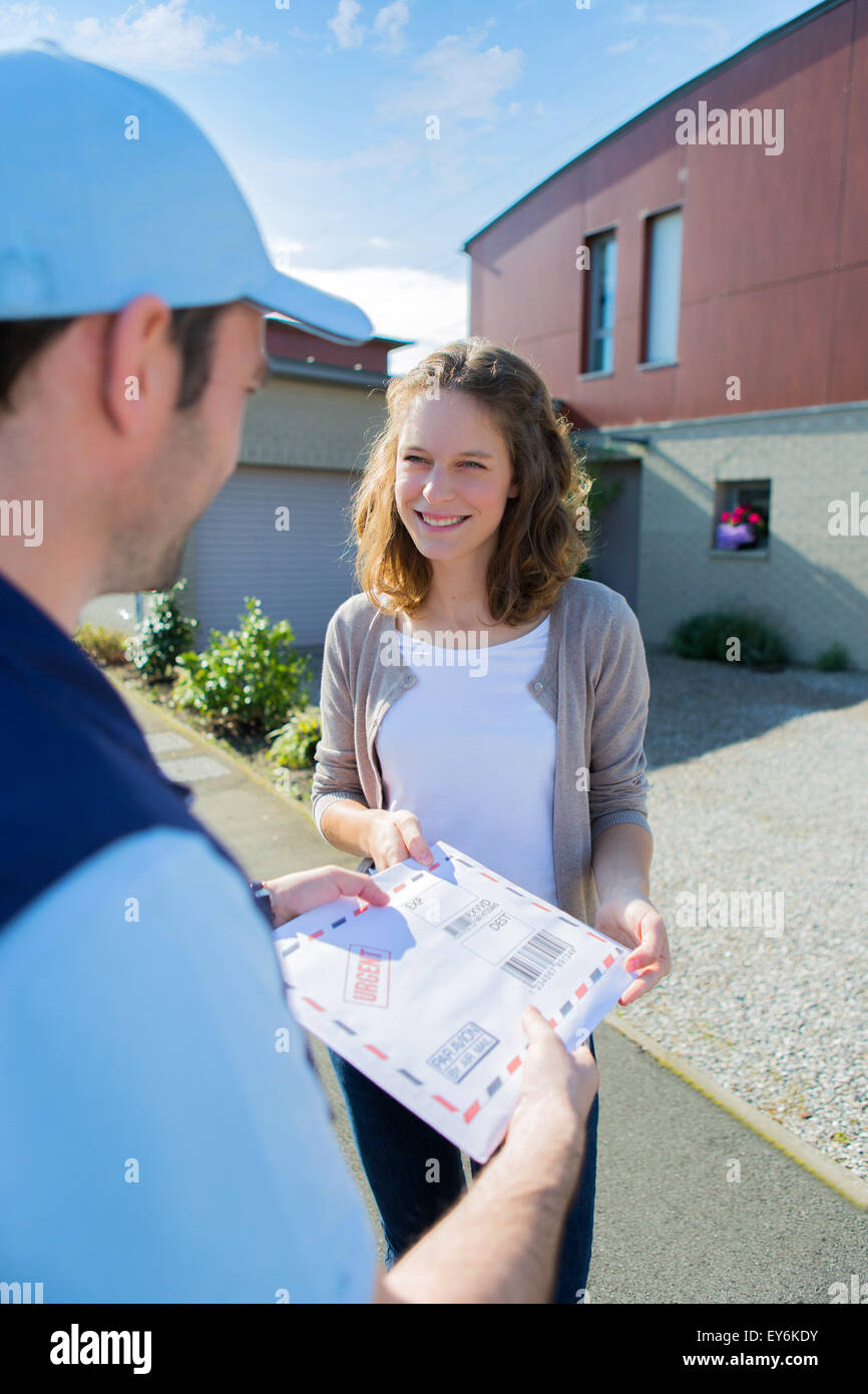 View of a Delivery man handing over a registered mail Stock Photo - Alamy