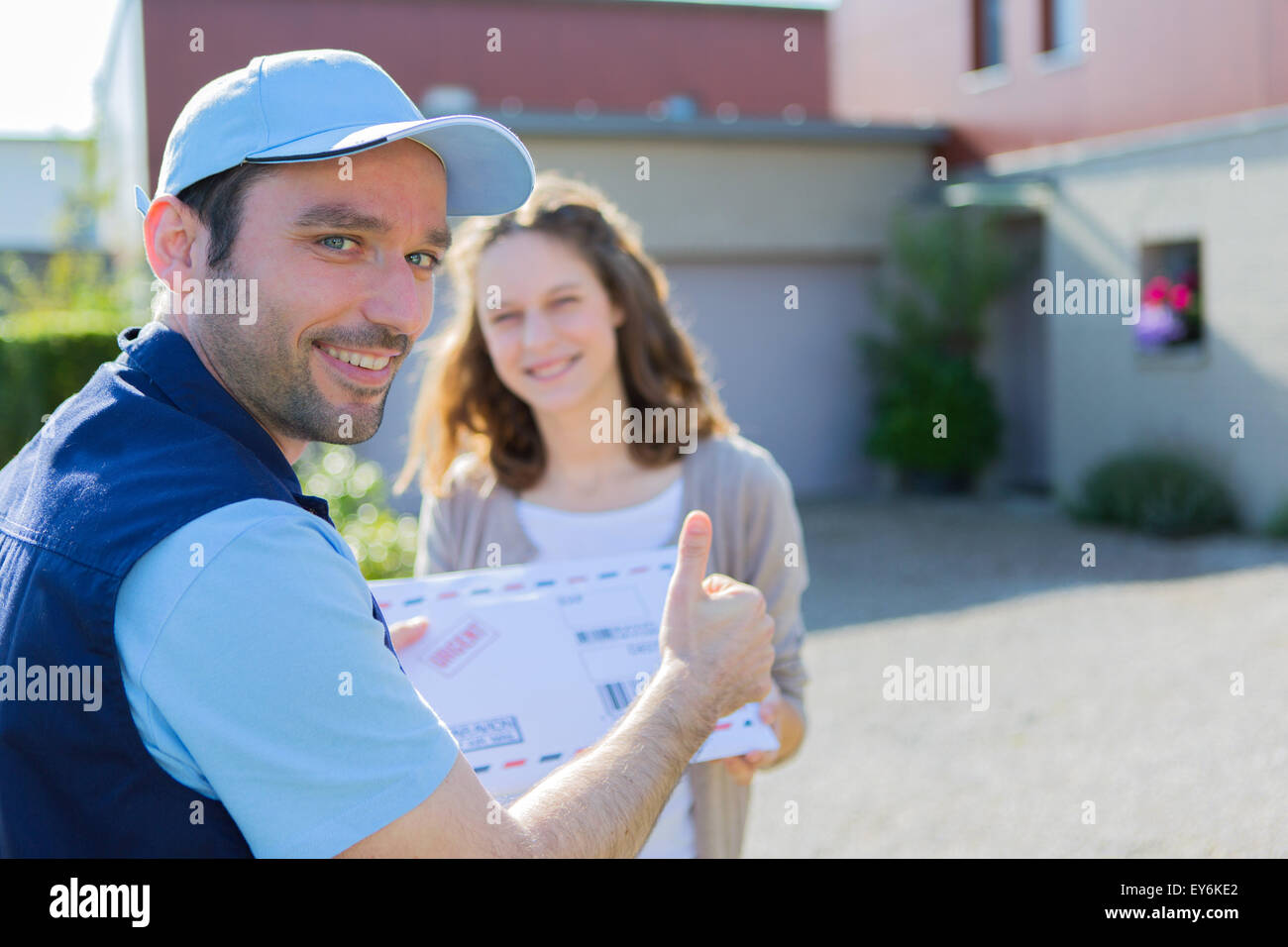 View of a Delivery man handing over a registered mail Stock Photo - Alamy
