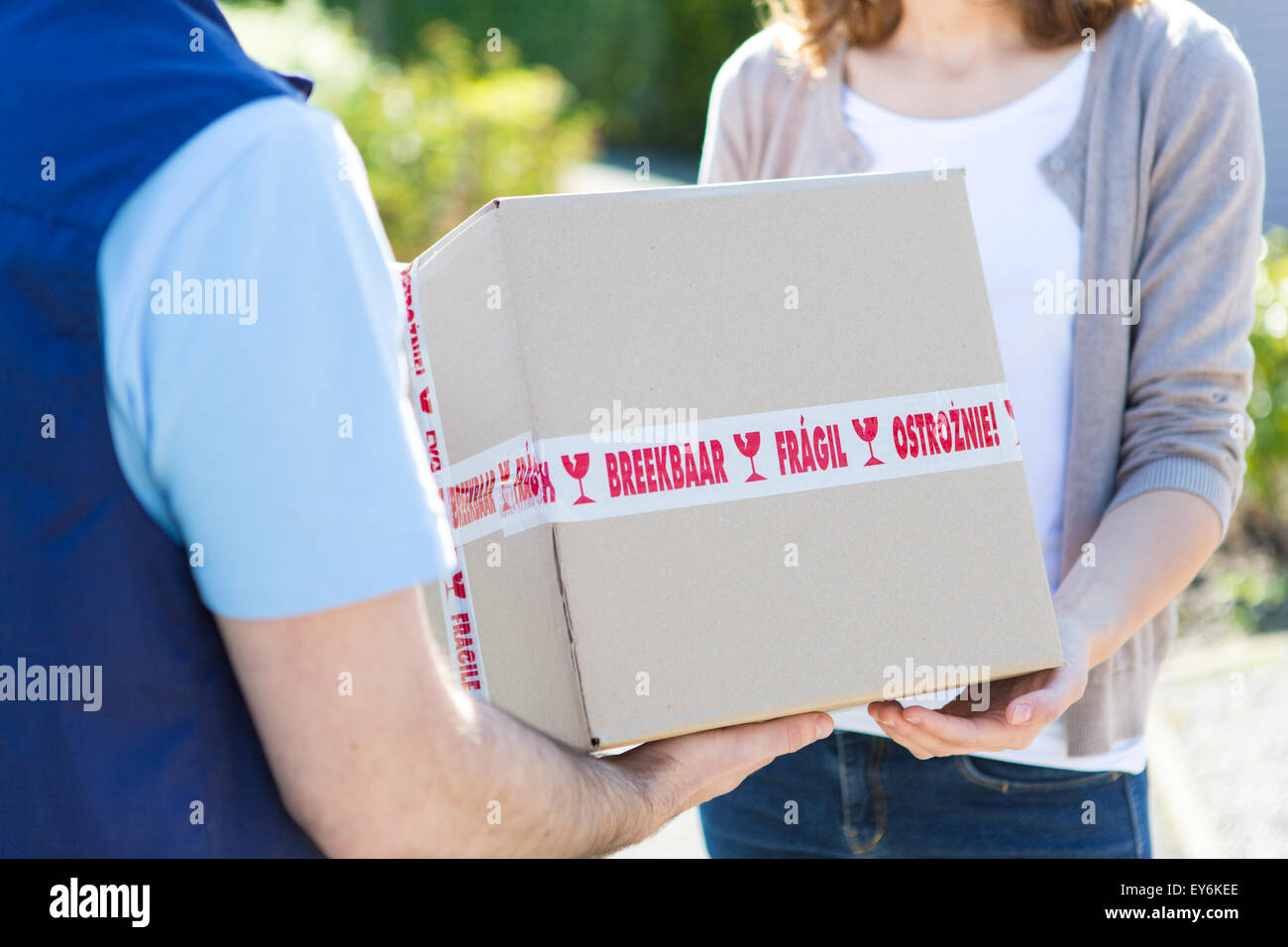 Detailed view of a parcel being handed over by a professional Stock ...