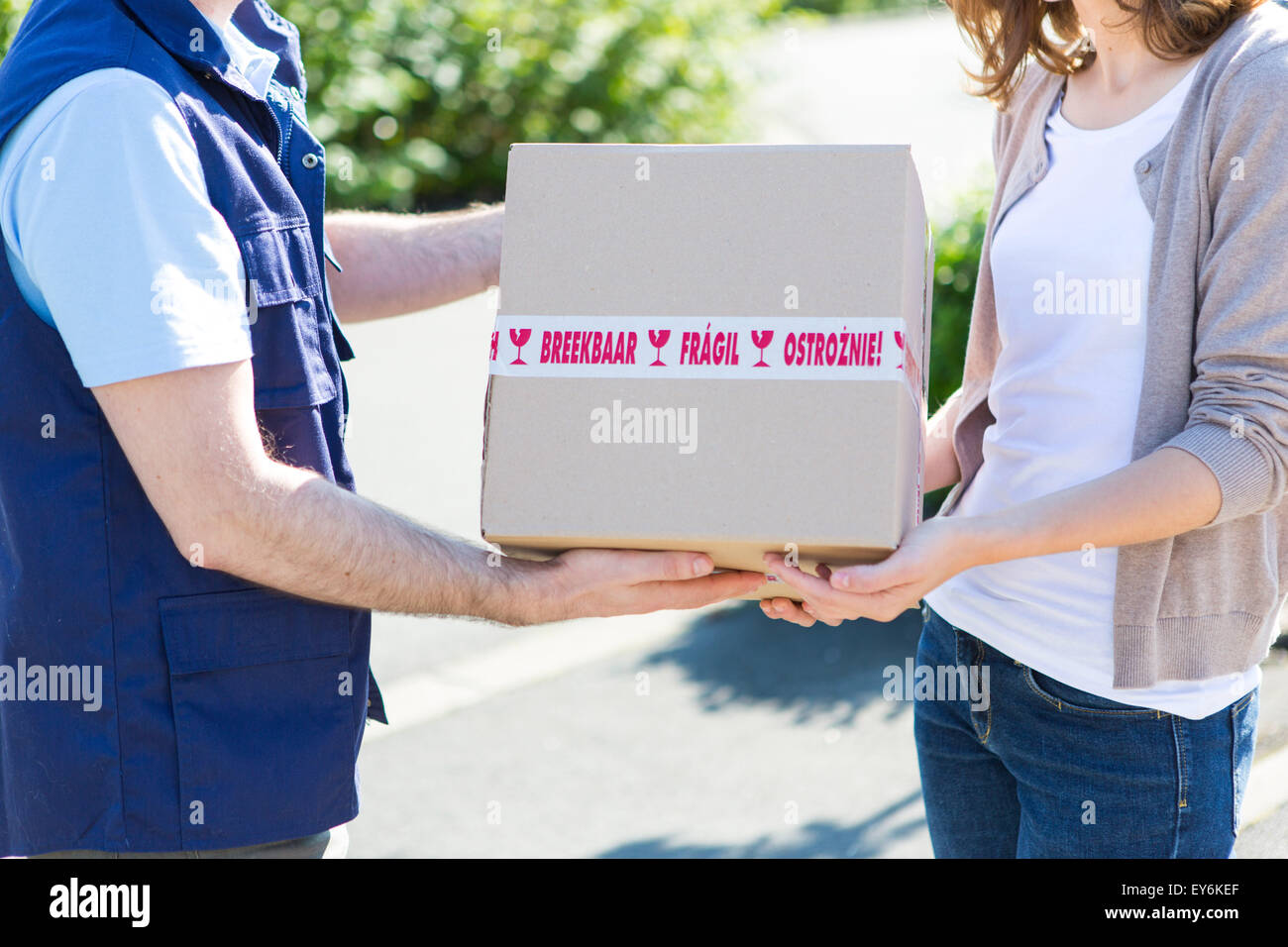 Detailed view of a parcel being handed over by a professional Stock ...