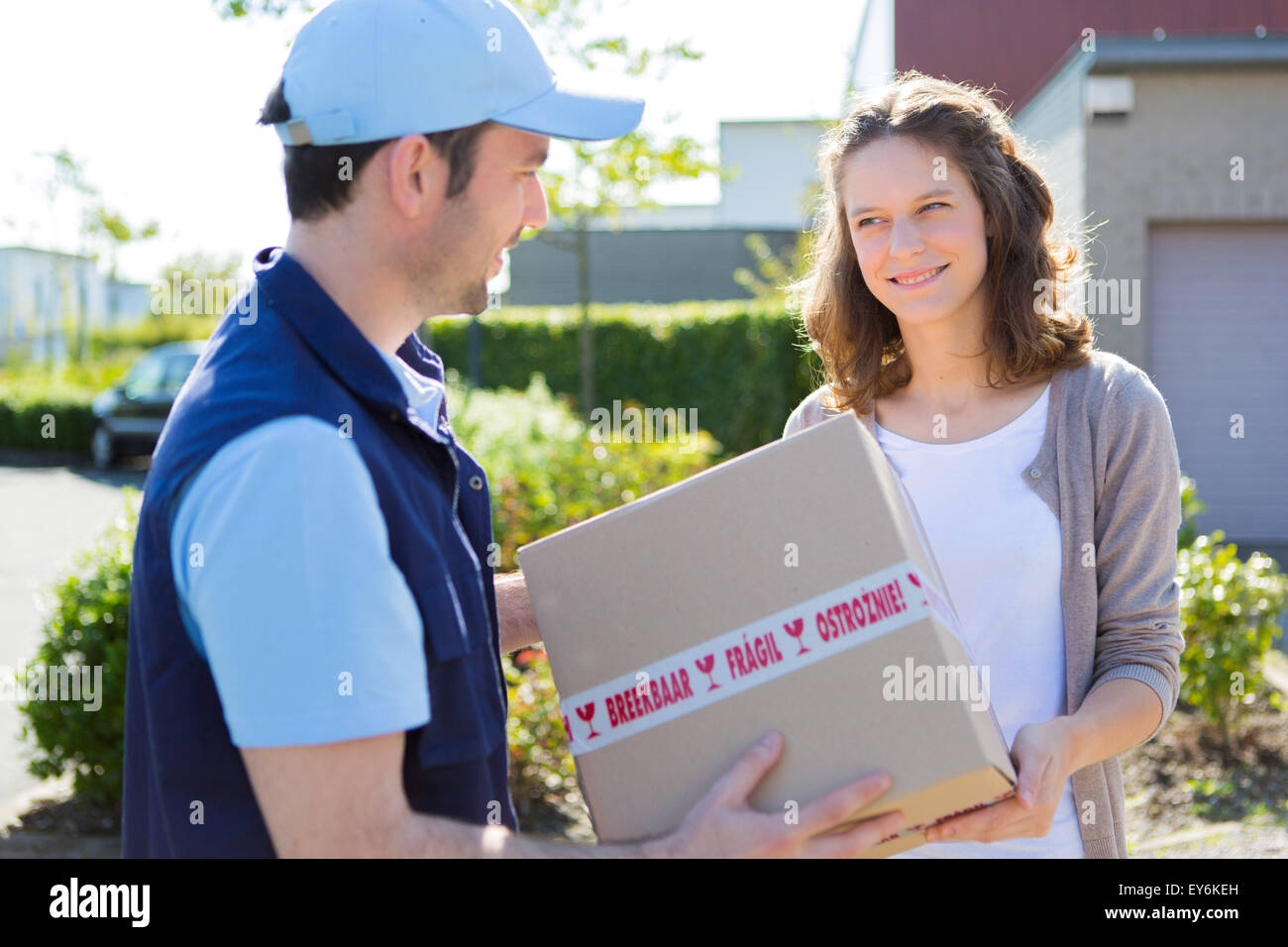 View of a Delivery man handing over a parcel to customer Stock Photo ...