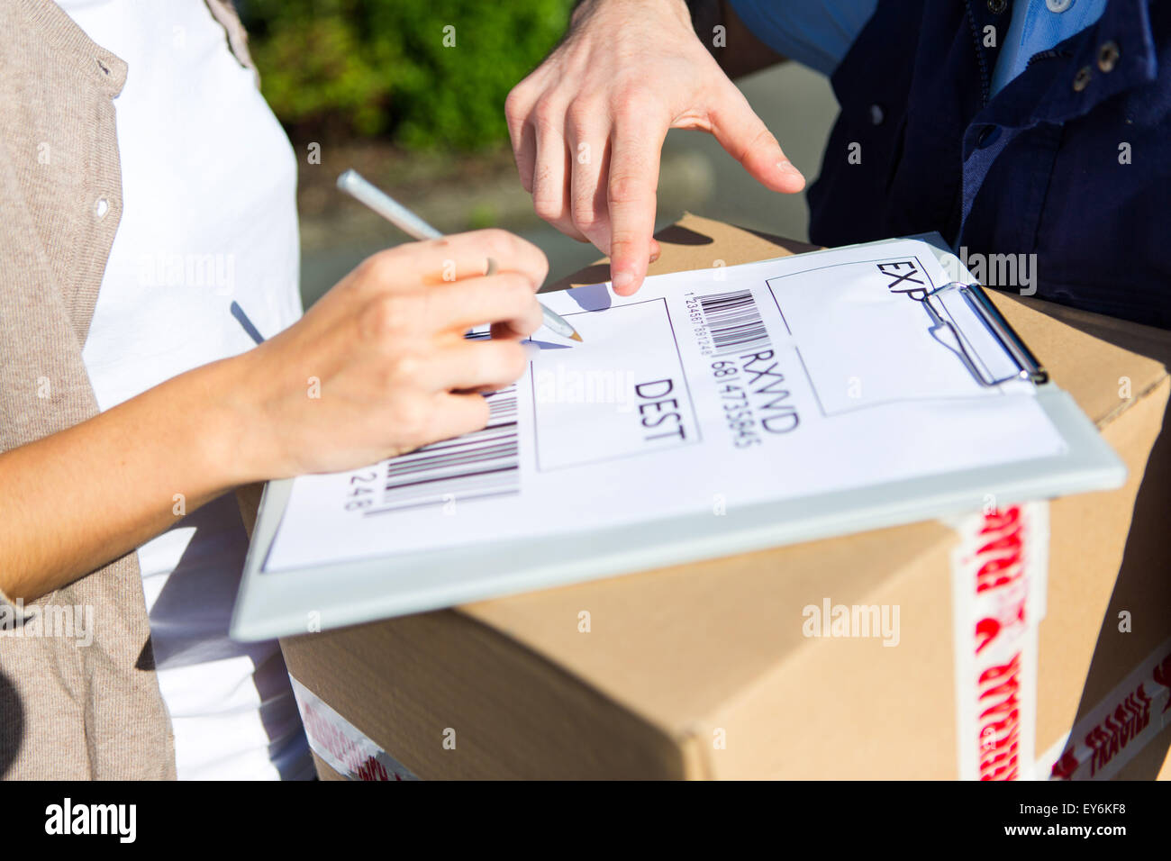 Detailed view of a customer signing delivery note Stock Photo - Alamy