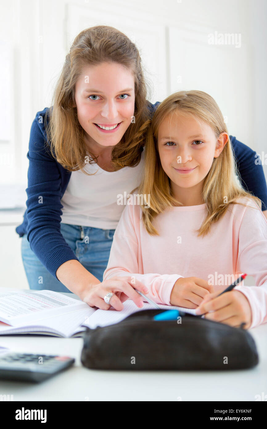 View of a Woman helping out her little sister for homework Stock Photo ...