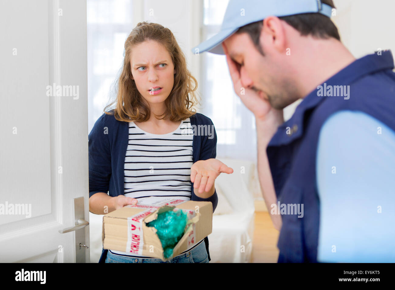 View of a Young attractive woman angry against delivery man Stock Photo ...
