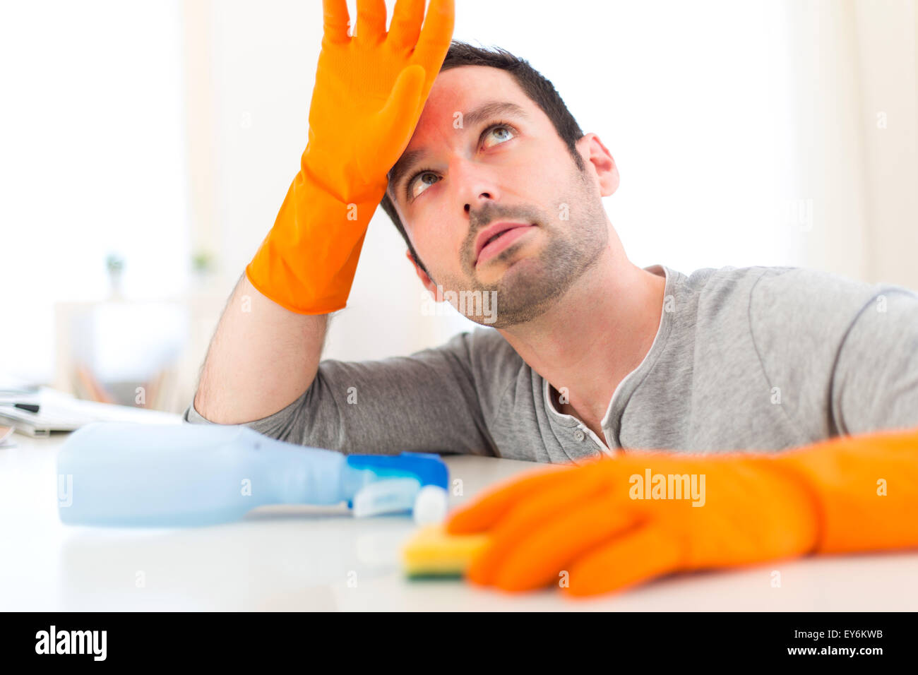 View of a Young attractive man cleaning his flat Stock Photo - Alamy