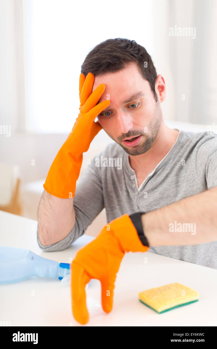 View of a Young attractive man cleaning his flat Stock Photo - Alamy