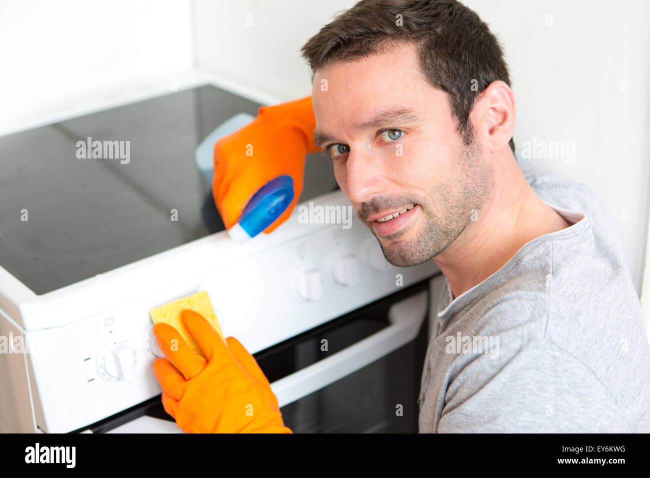 View of a Young attractive man cleaning his flat Stock Photo - Alamy