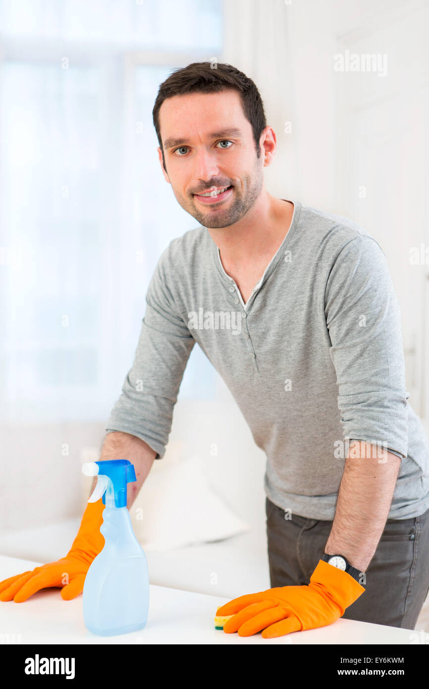 View of a Young attractive man cleaning his flat Stock Photo - Alamy