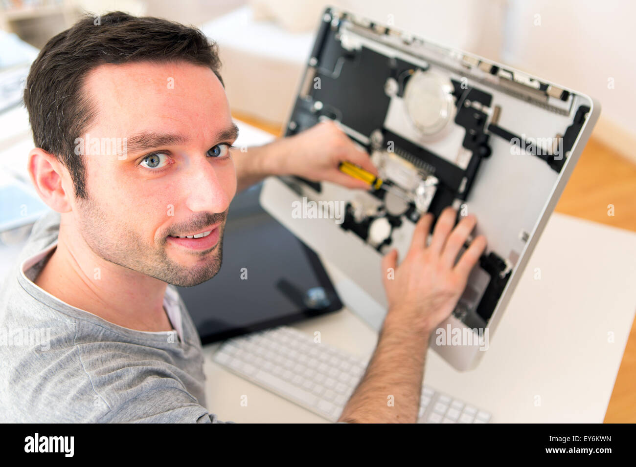 View of a Young attractive man repairing a computer Stock Photo - Alamy