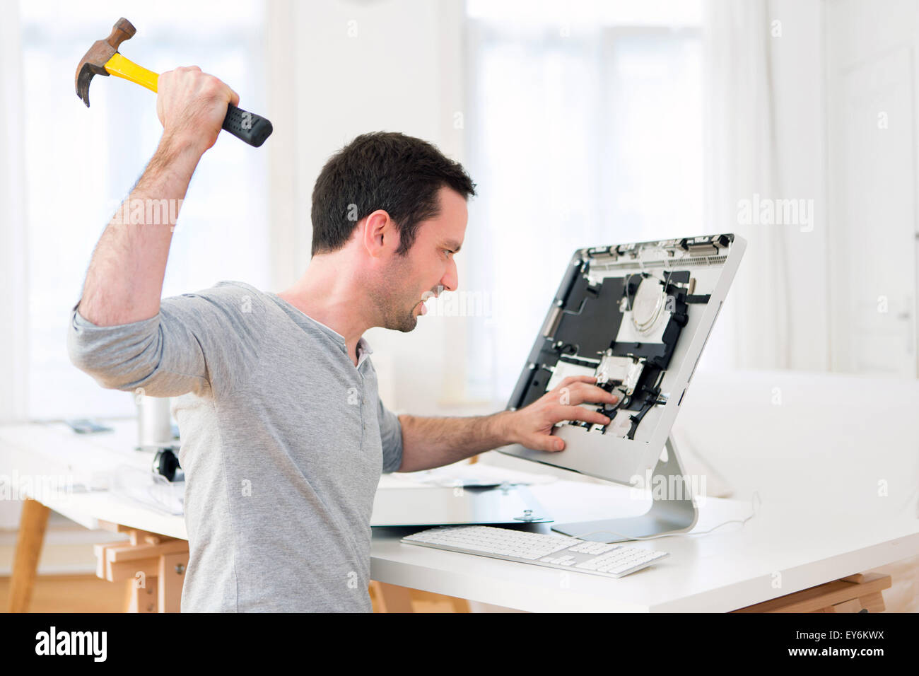 View of a Young attractive man angry against computer Stock Photo - Alamy