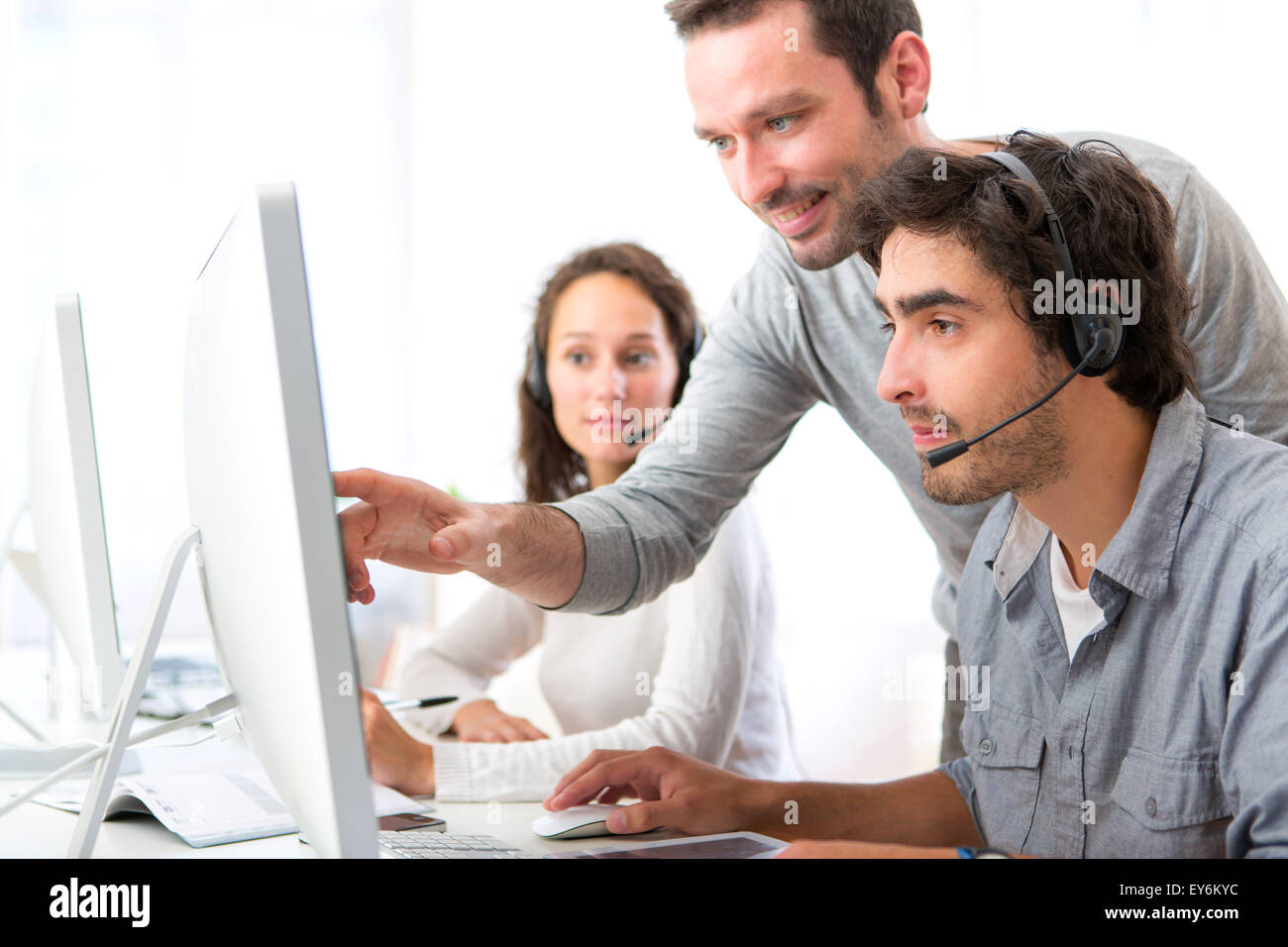 View of a Group of people working around a computer Stock Photo - Alamy