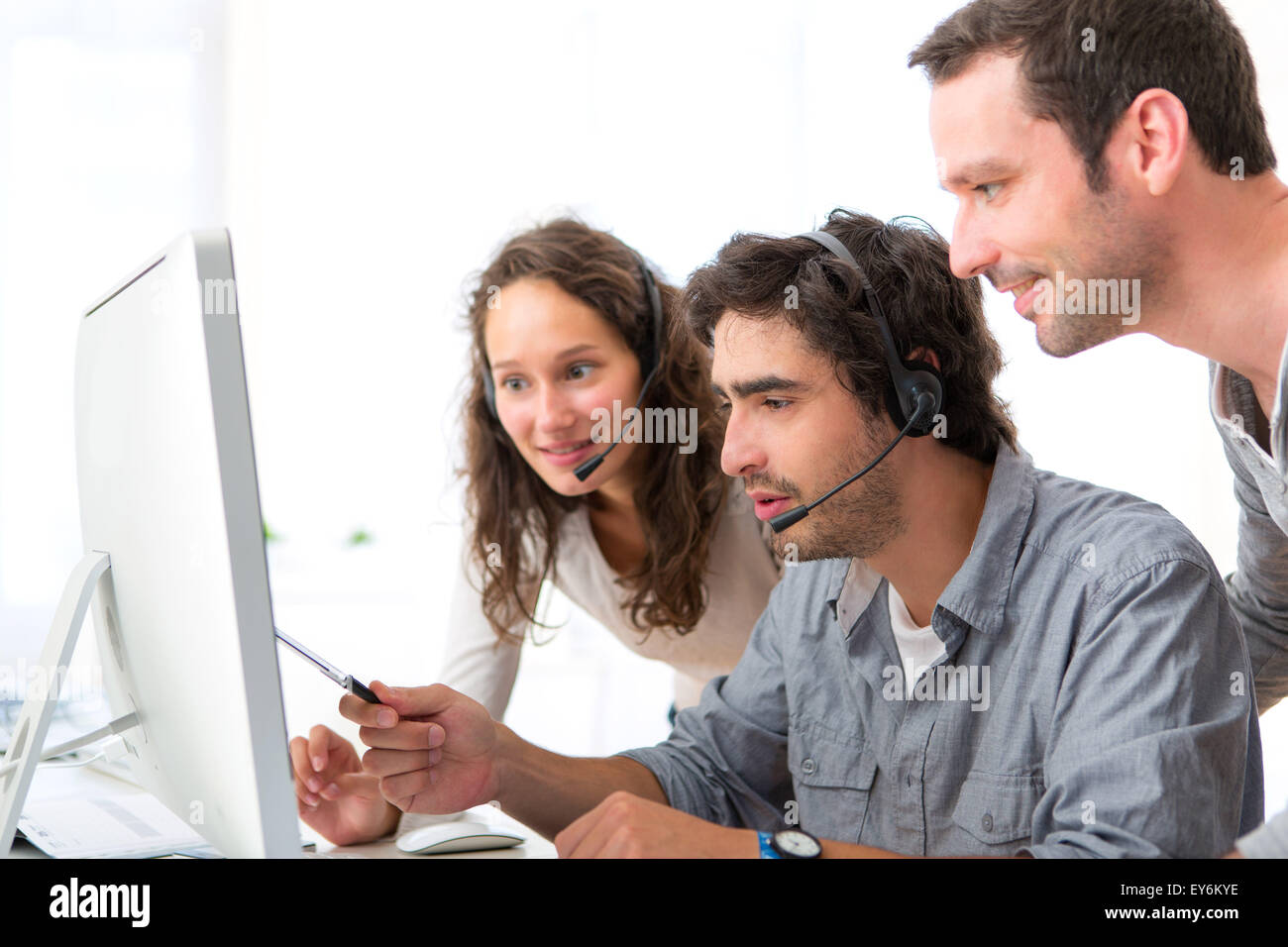 View of a Group of people working around a computer Stock Photo - Alamy