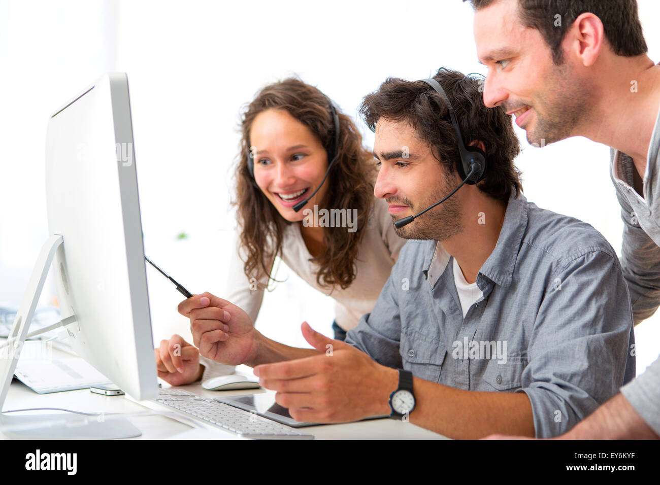 View of a Group of people working around a computer Stock Photo - Alamy
