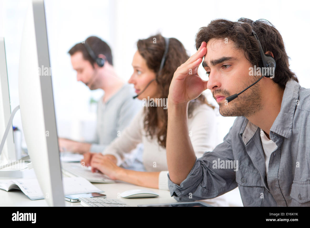 View of a Young attractive man ill-at-ease at work Stock Photo - Alamy