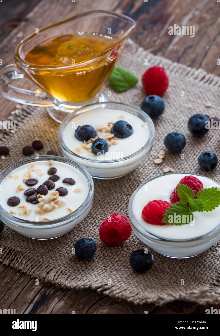 Three Little Bowls Full of Healthy Yogurt with Fruit or Chocolate and ...