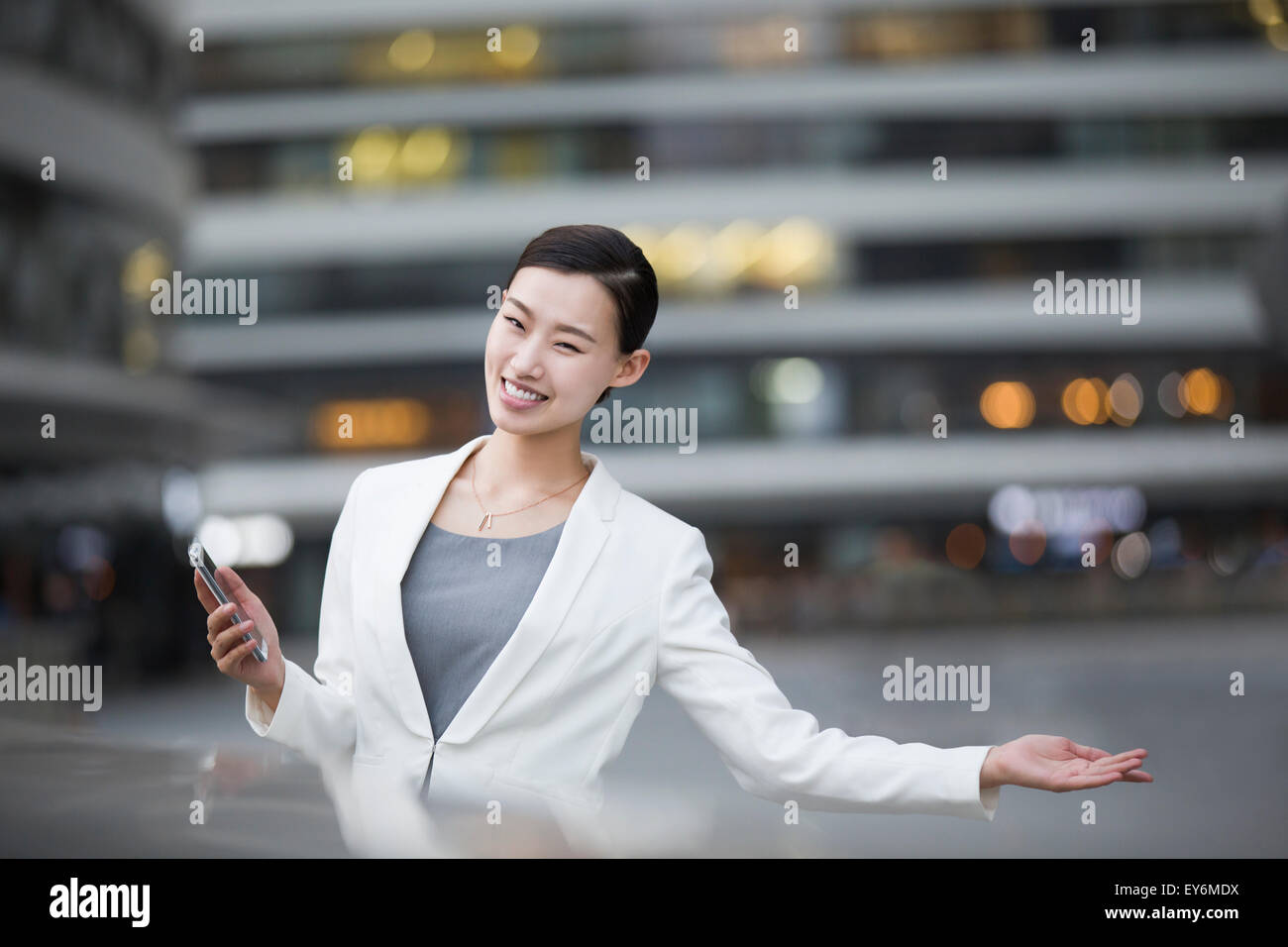 Businesswoman making a welcome gesture Stock Photo - Alamy