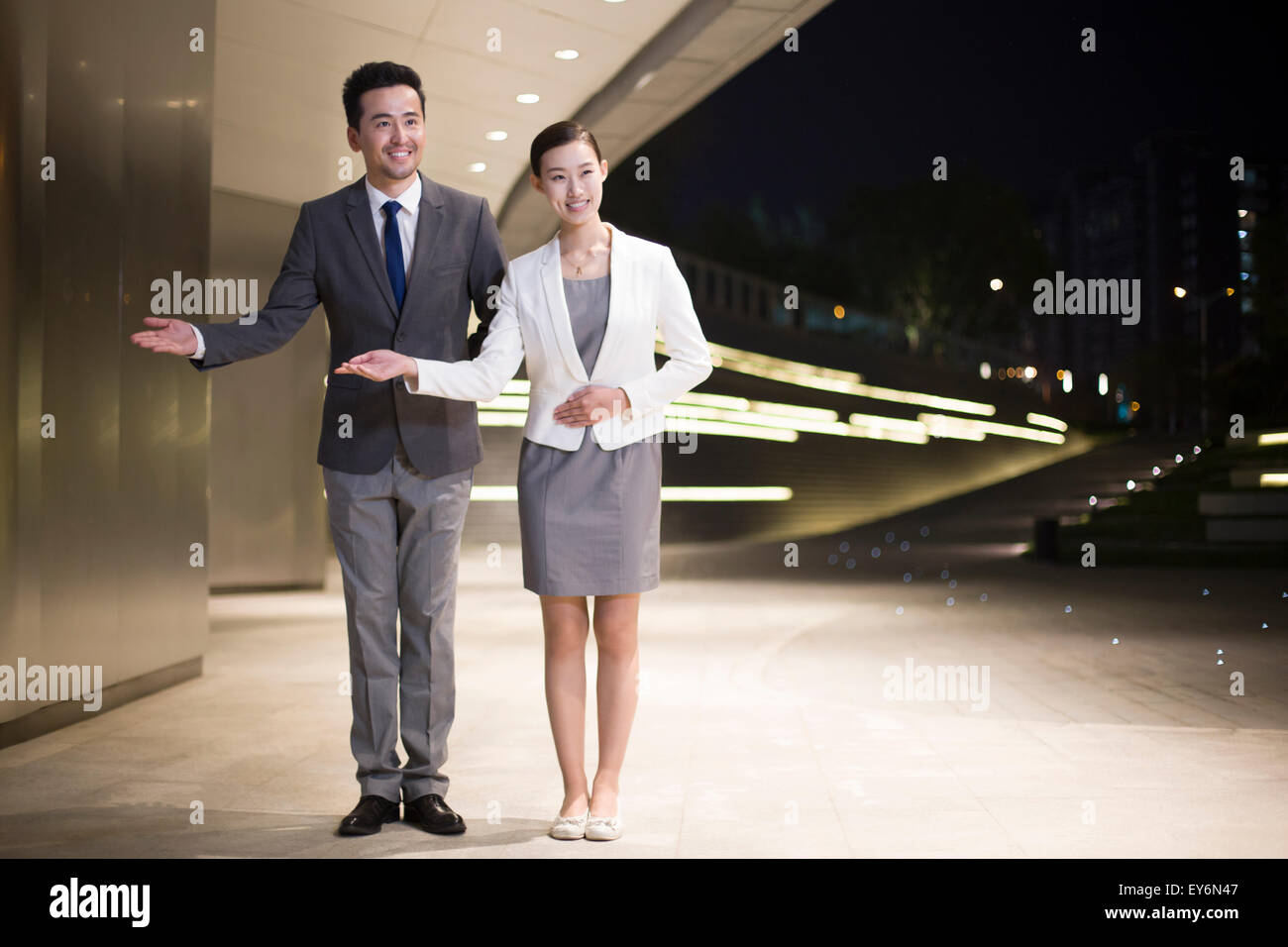 Business person making welcome gesture Stock Photo - Alamy
