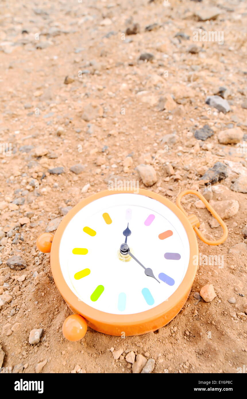 Classic Analog Clock In The Sand Stock Photo - Alamy