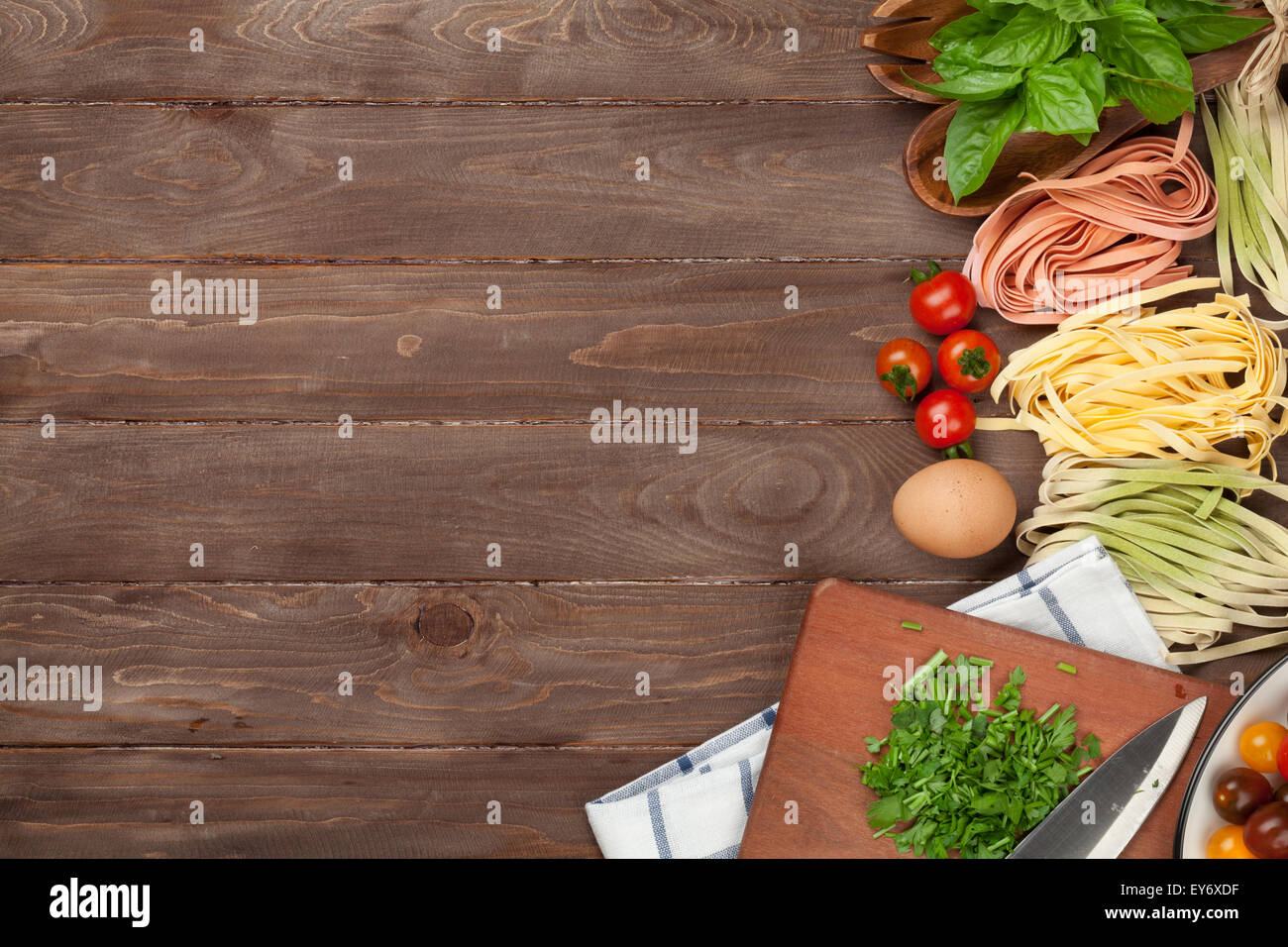 Pasta cooking ingredients and utensils on wooden table. Top view with ...