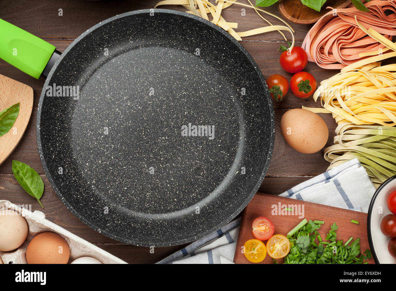 Pasta cooking ingredients and utensils on wooden table. Top view with ...