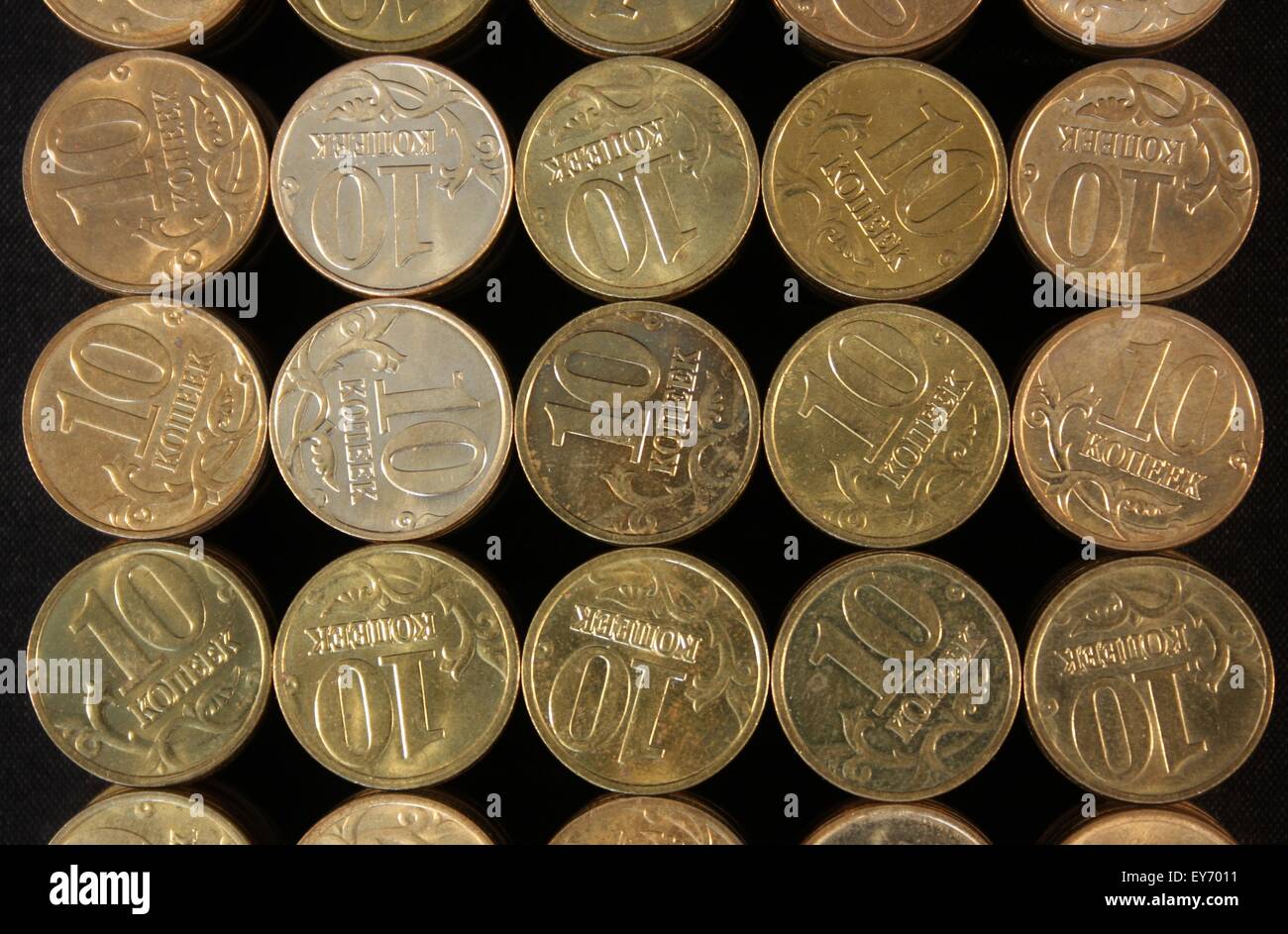Coins stacked on a black background Stock Photo - Alamy