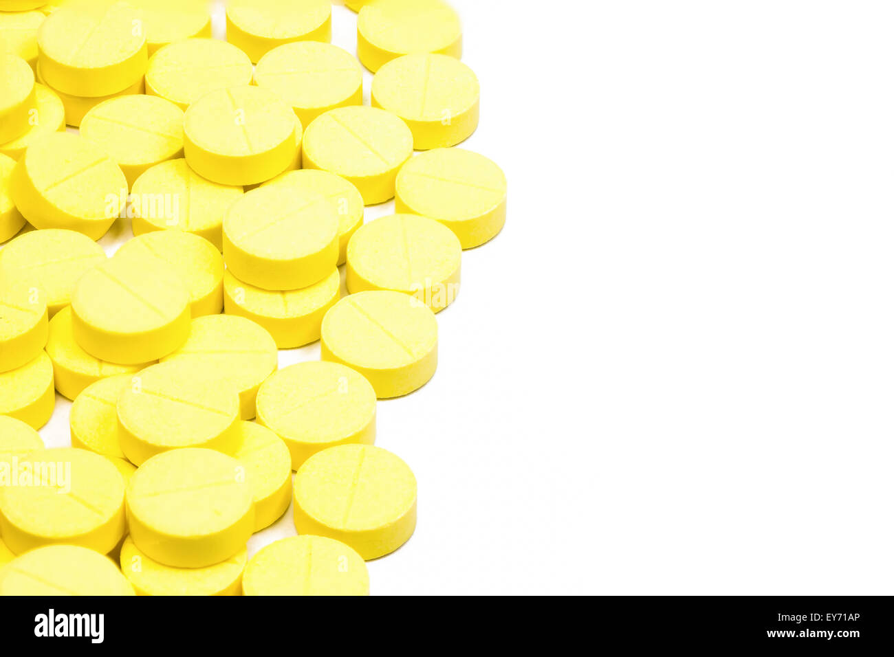 Many yellow medicine on the white background Stock Photo - Alamy