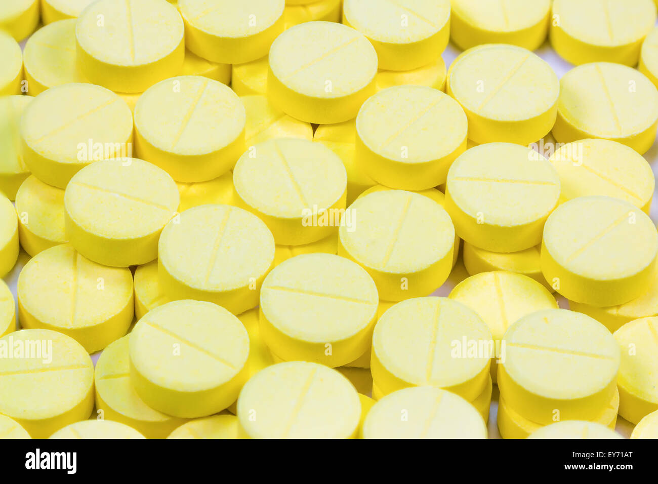 Many yellow medicine on the white background Stock Photo - Alamy