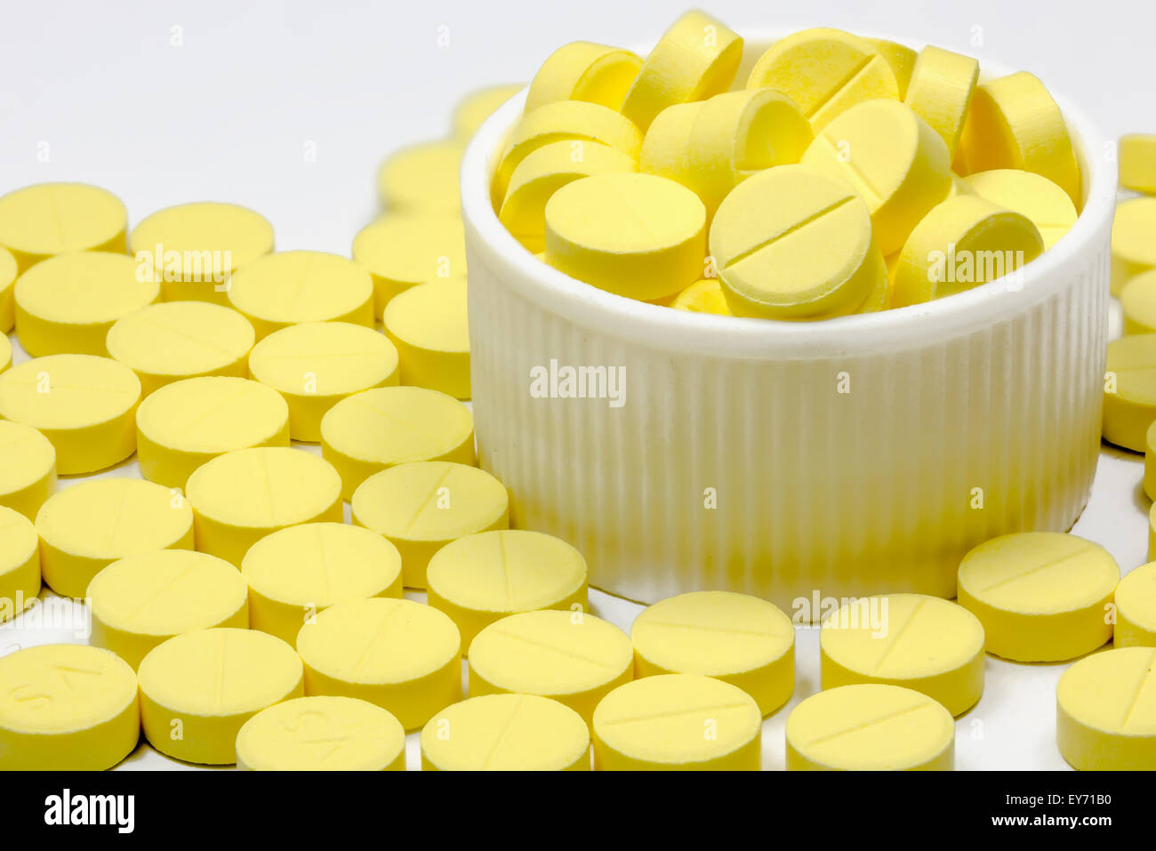 Yellow medicine spilling out of a bottle Stock Photo - Alamy