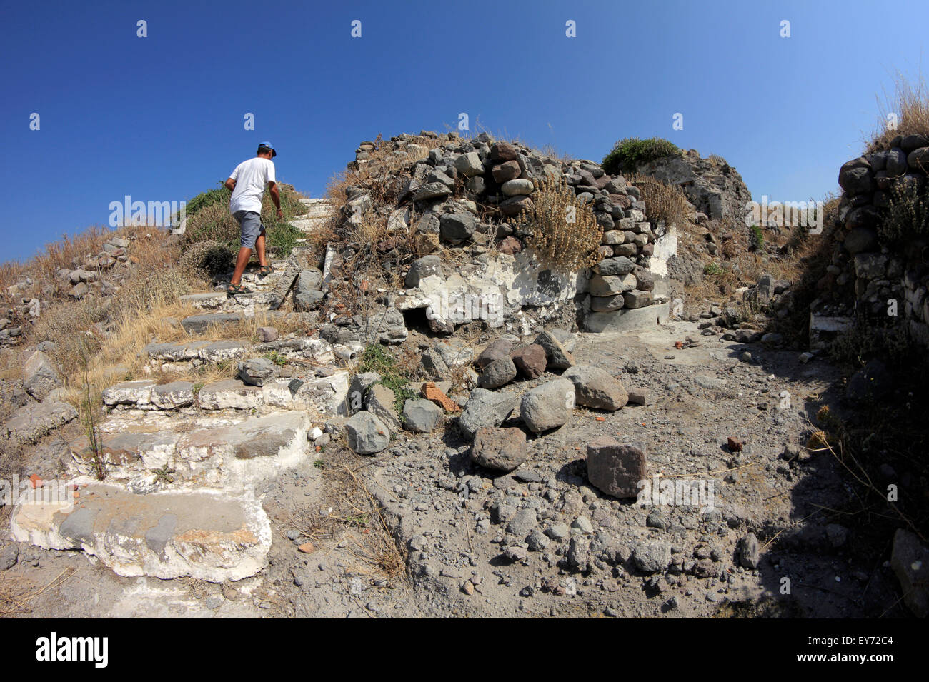 Tourist walking in the ancient old castle alley stone paths in Agios ...