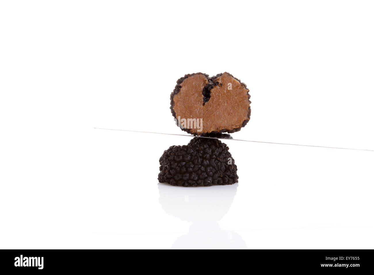 Cut truffles with knife isolated on white background. Luxurious ...