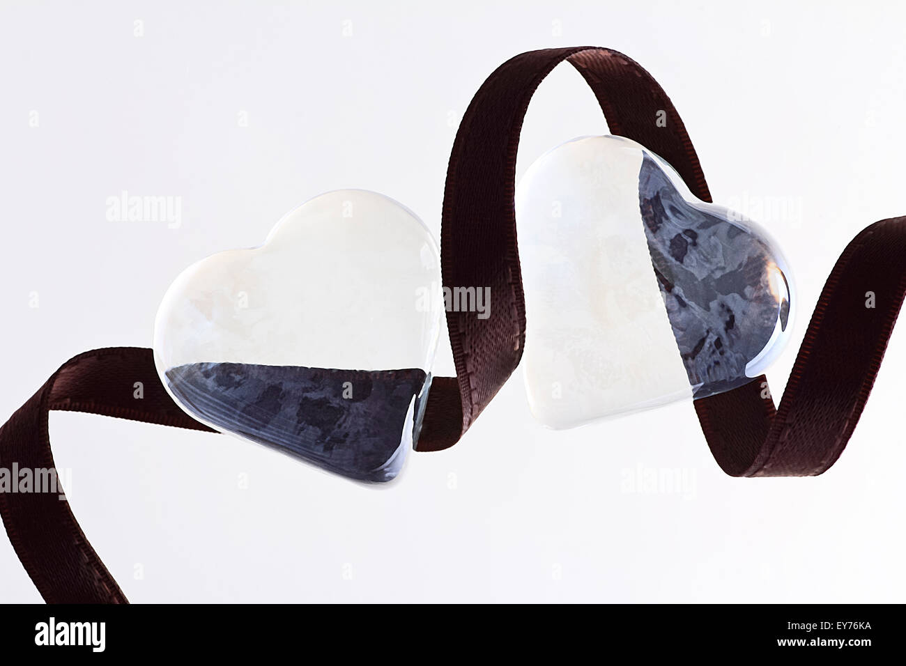 Two hearts with brown ribbon linked together Stock Photo - Alamy