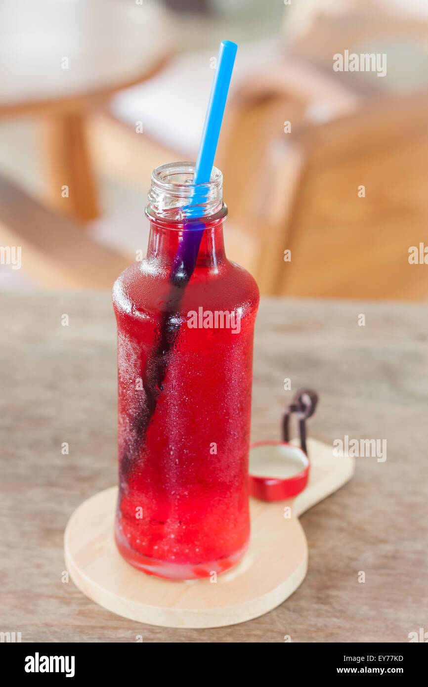 Red syrup in the bottle on wooden plate, stock photo Stock Photo - Alamy