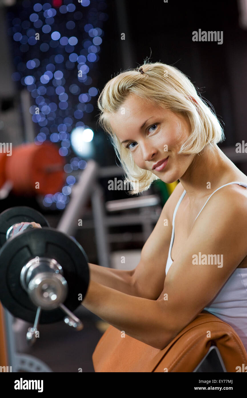 Strong beautiful woman lifting heavy weights Stock Photo - Alamy