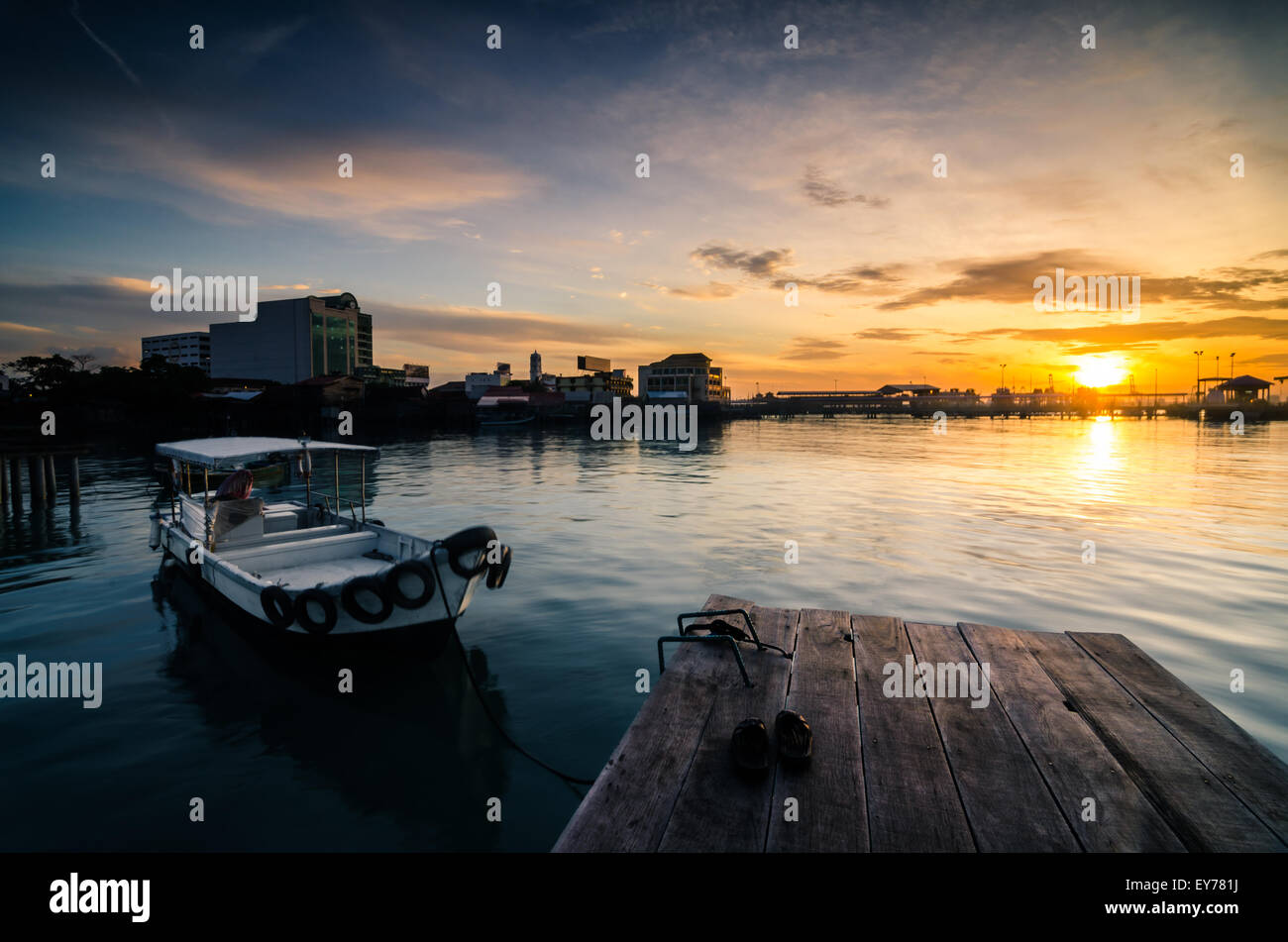 Wooden bridge of Clan Chew Jetty during sunrise in George Town, Penang ...