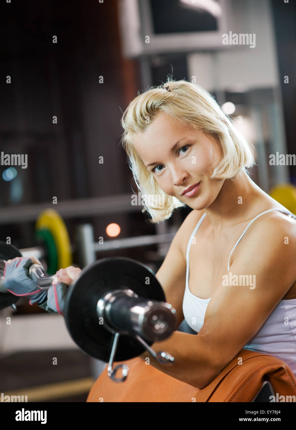 Strong beautiful woman lifting heavy weights Stock Photo - Alamy